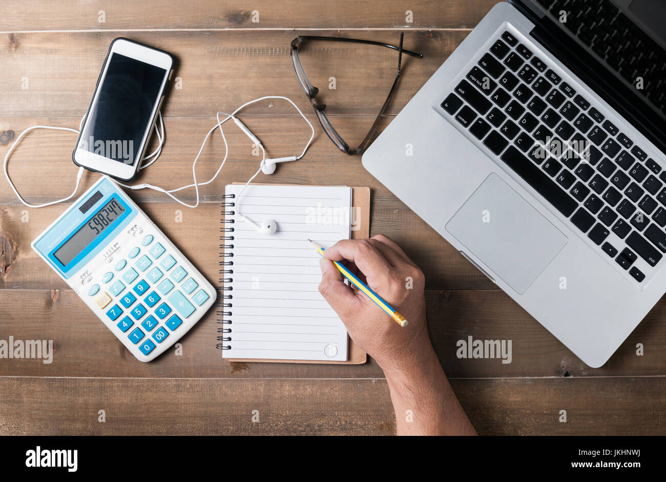Office desk table with laptop, calculator, smartphone, pencil and ...