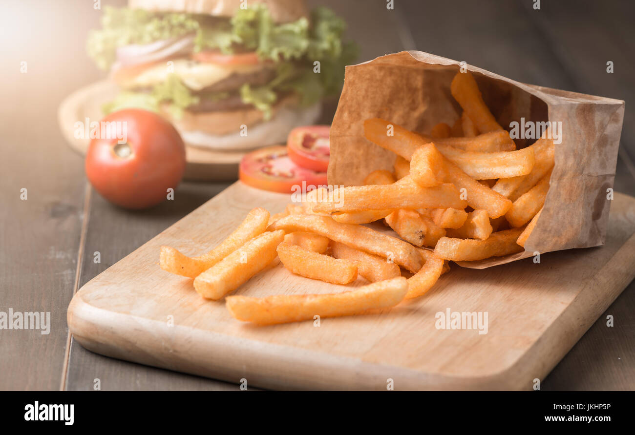 french fries mix cheese powder on wood block and dark wood background ...