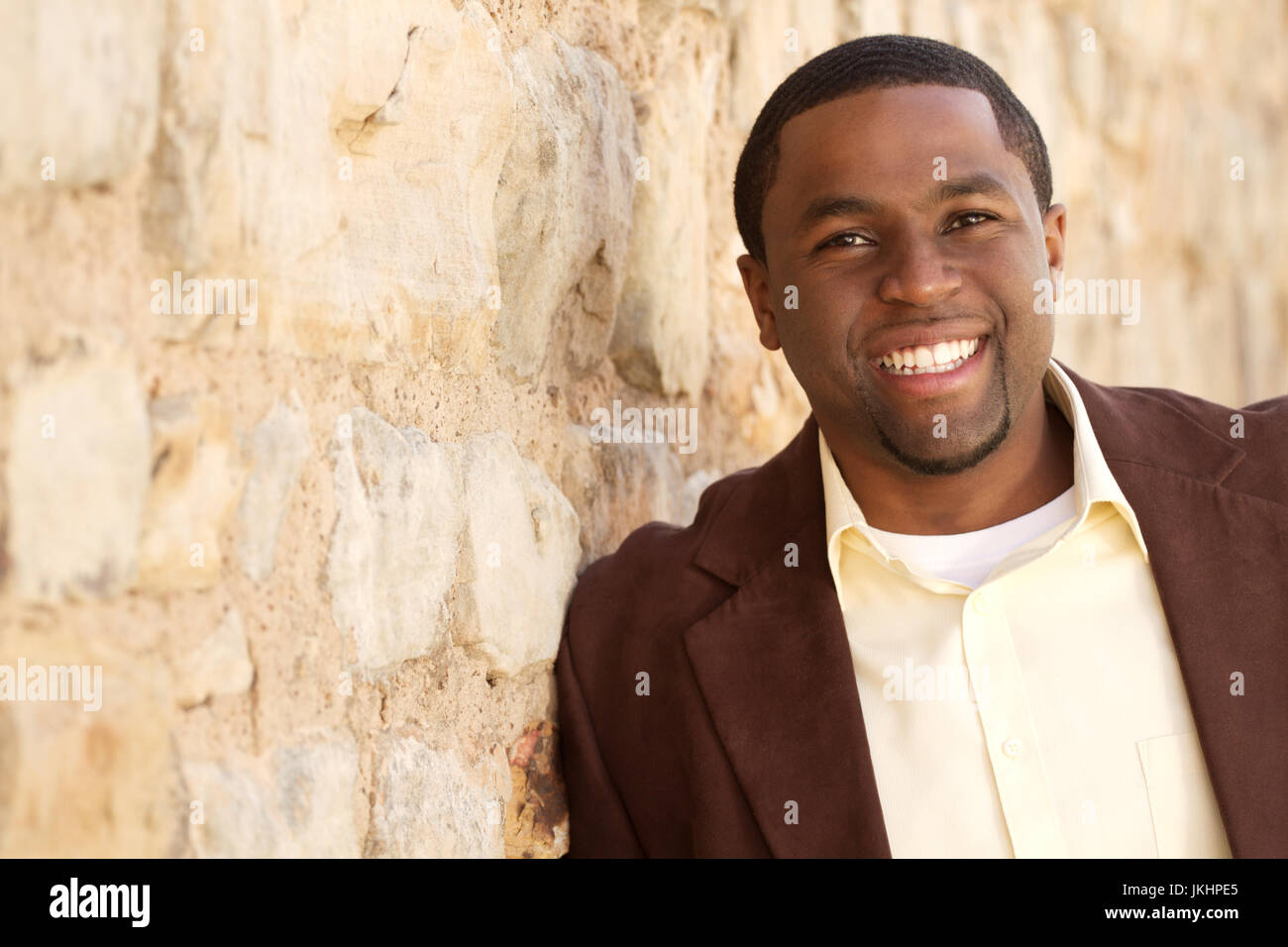 Young African American man smiling outside Stock Photo - Alamy