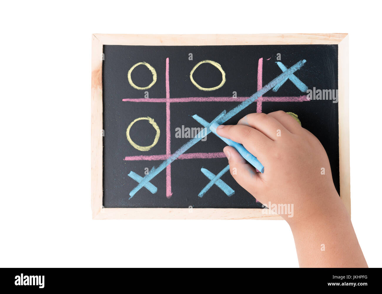 boy hand drawing a game of tic tac toe on a black chalkboard isolated ...
