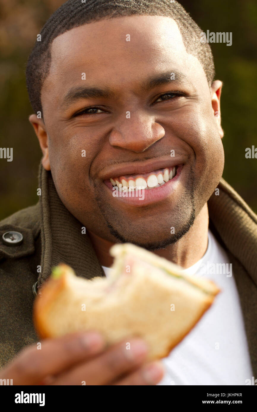 Young African American man smiling outside Stock Photo - Alamy
