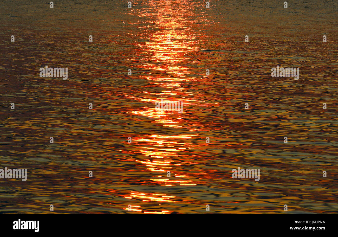 Water surface with sunlight on sunset. Abstract background for romantic ...