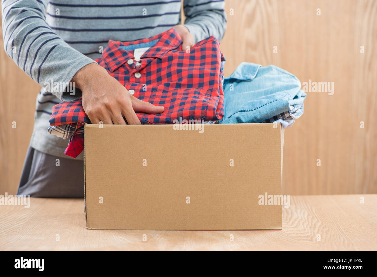 Donation box for poor with clothing in male hands Stock Photo - Alamy