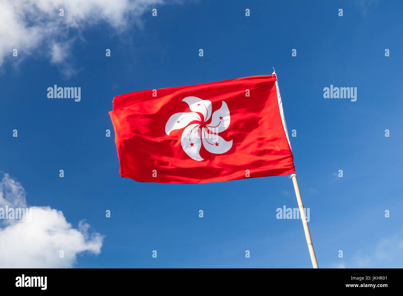 Hong Kong flag over blue cloudy sky background Stock Photo - Alamy