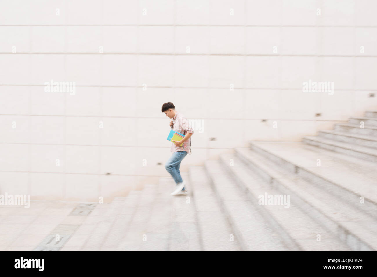 Male student going down the stairs, blurred motion Stock Photo - Alamy