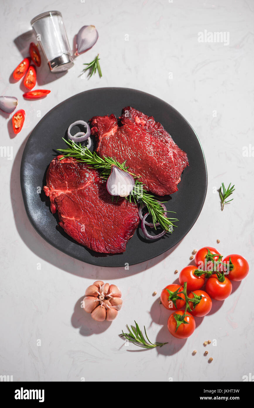 Raw fresh beef on white stone background, top view Stock Photo - Alamy