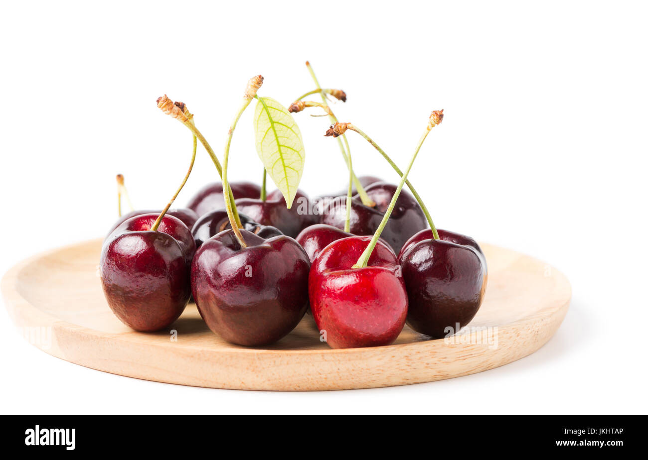 cherry on wood plate isolated on white background Stock Photo - Alamy