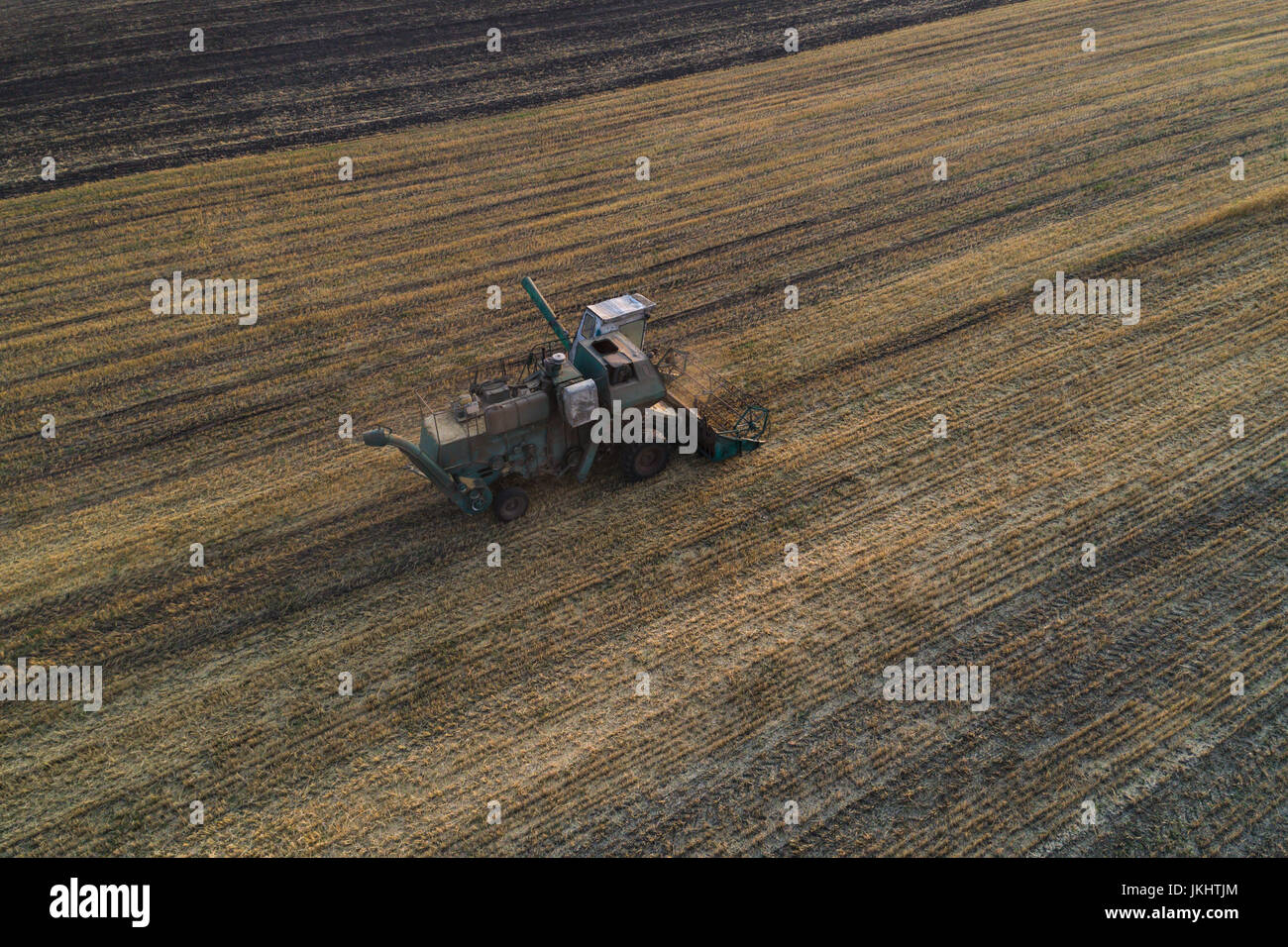 Harvester machine working in field . Combine harvester agriculture ...
