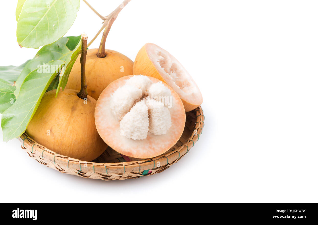 sliced santol fruit in bamboo basket isolated on white background Stock ...
