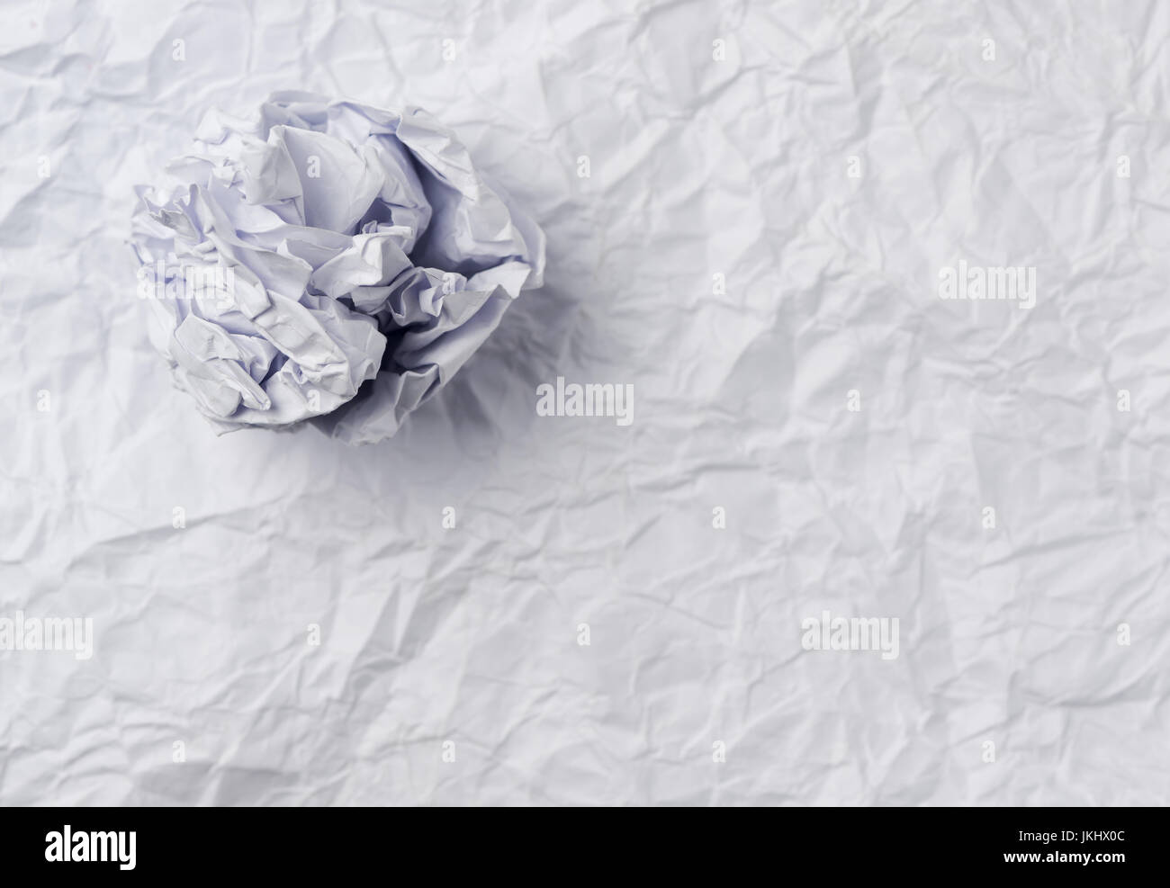 crumpled paper ball on crumpled paper background Stock Photo - Alamy