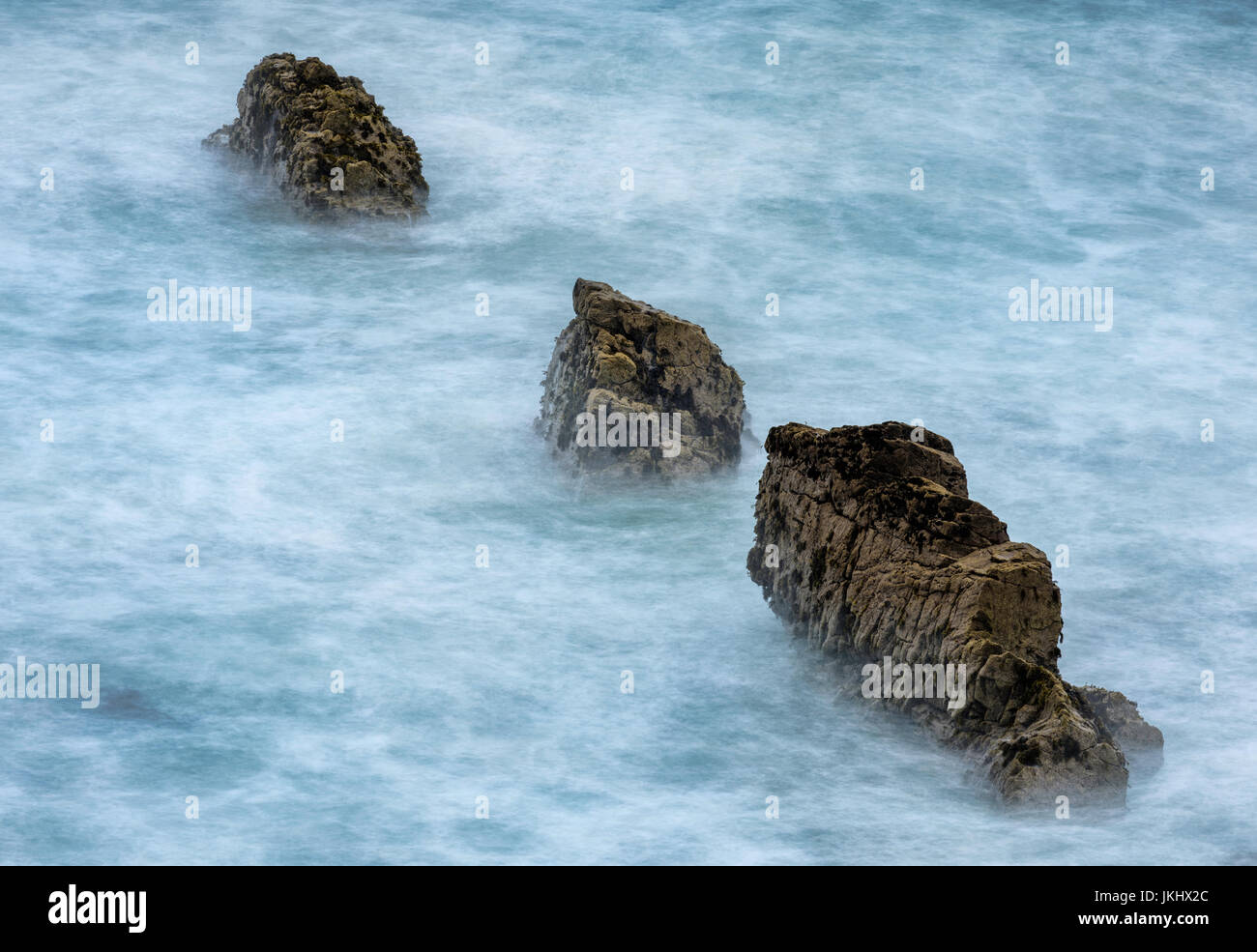 Three Rocks in Sea Stock Photo - Alamy