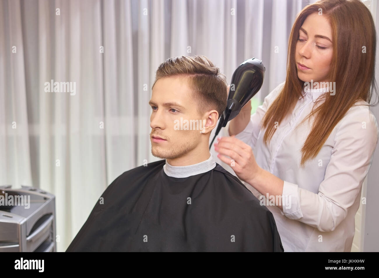 Young man in hair salon Stock Photo - Alamy