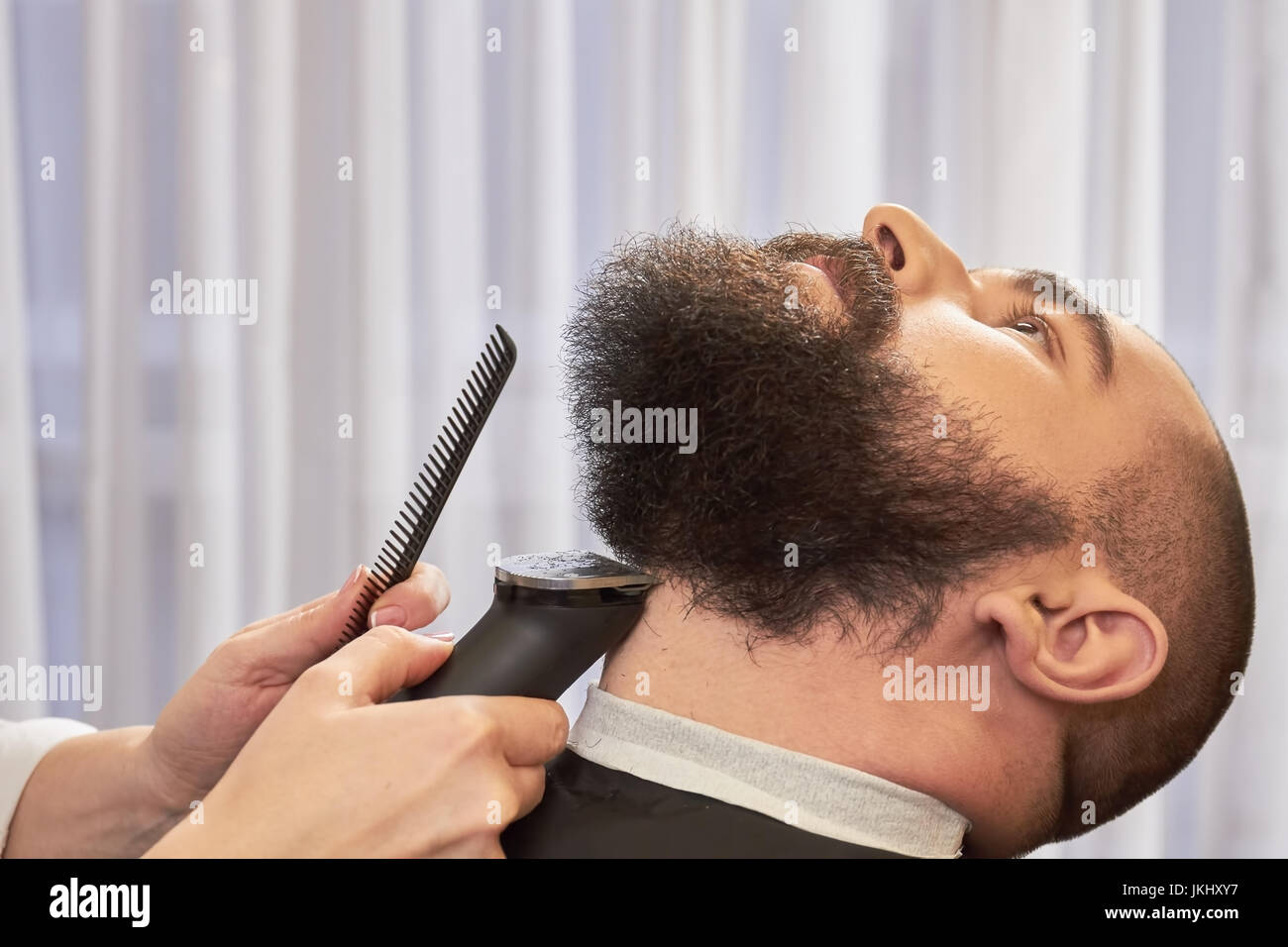Hand of barber trimming beard Stock Photo - Alamy