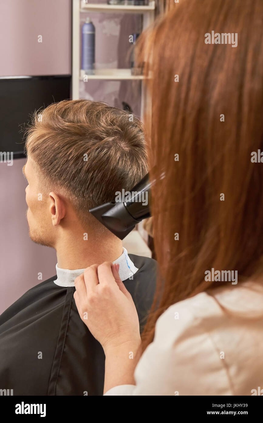 Barber and customer, blow dryer Stock Photo - Alamy