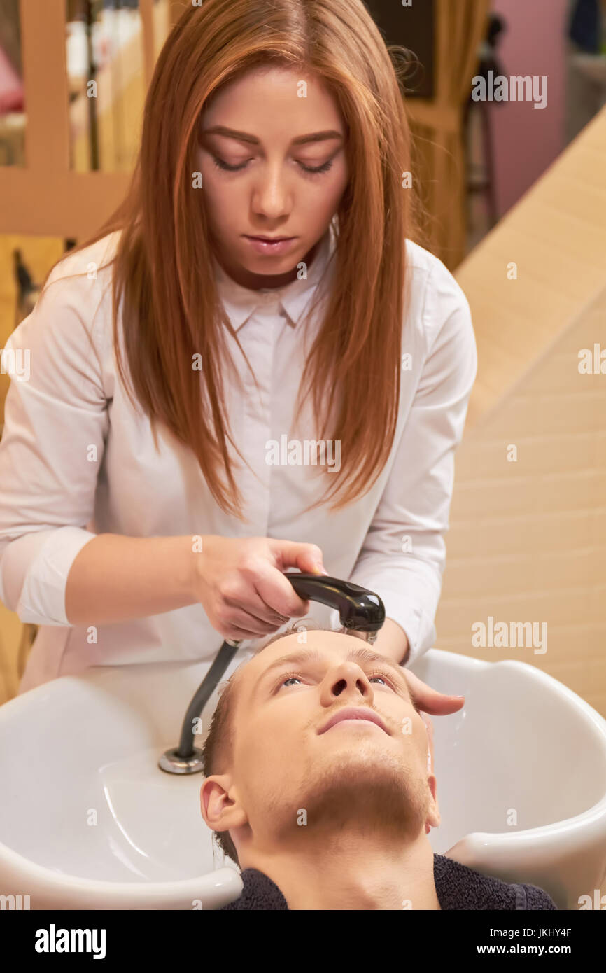 Man getting his head washed Stock Photo - Alamy