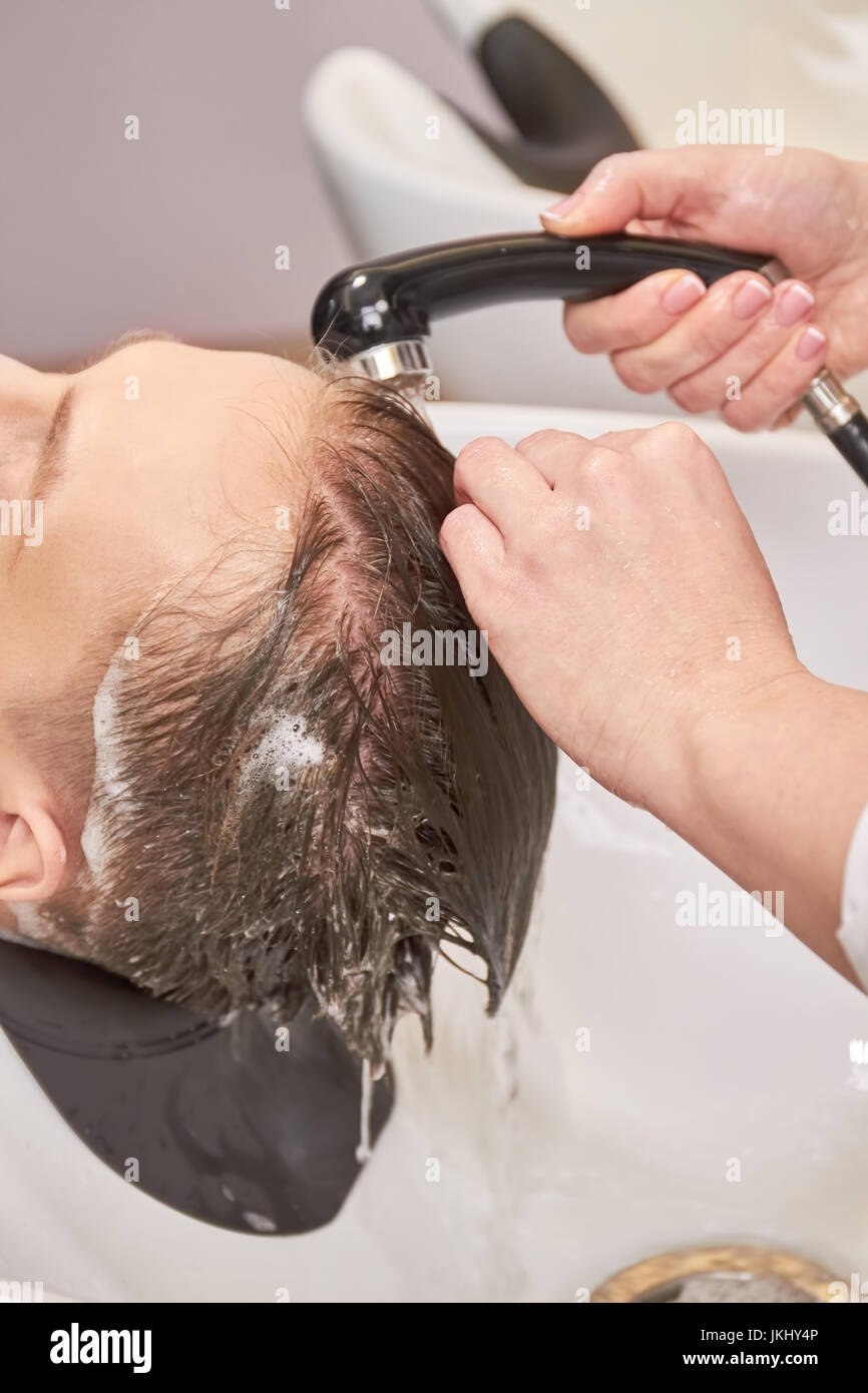 Hands of barber washing hair Stock Photo - Alamy
