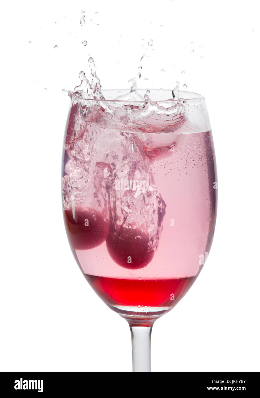 cherry in red cocktail with splash isolated on white Stock Photo - Alamy