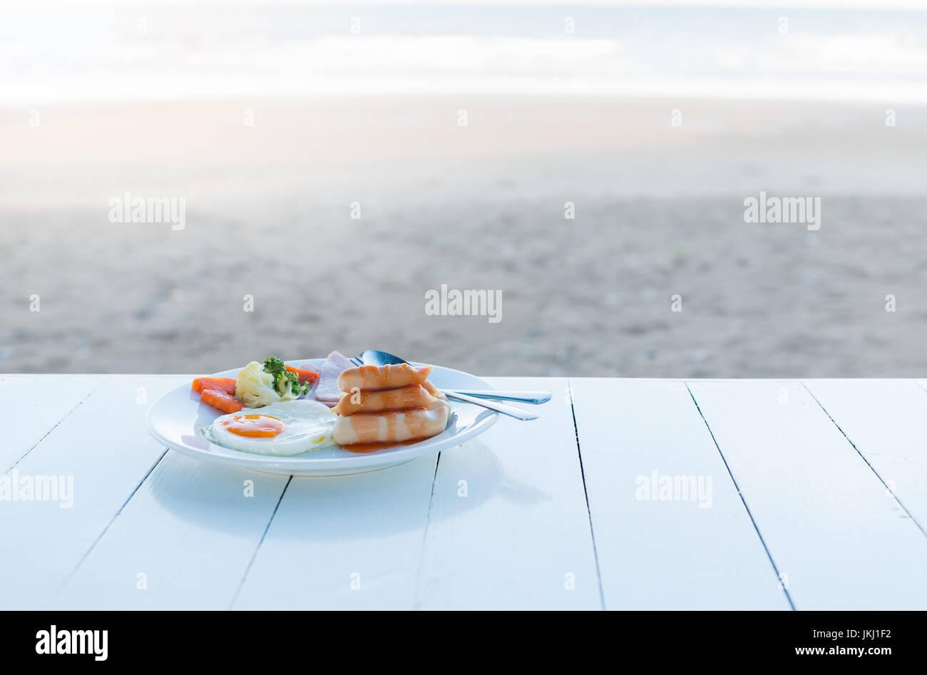 breakfast set on white table and sand with sea background Stock Photo ...