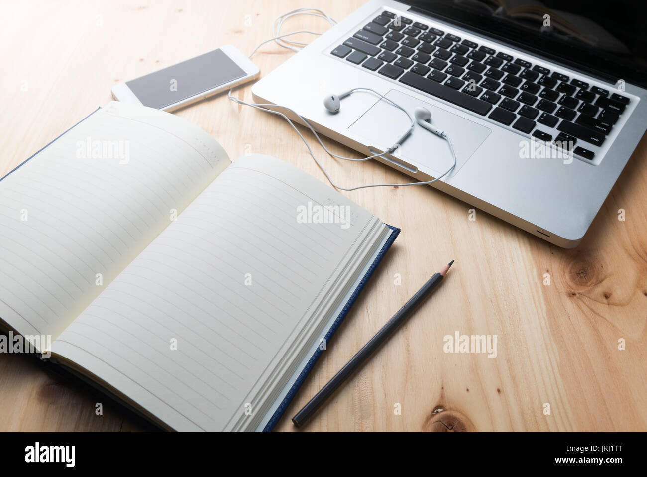 blank notebook with pencil and laptop on wood background Stock Photo ...