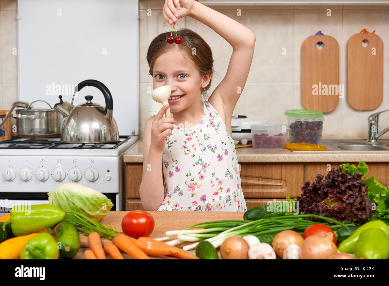 child girl with fruits and vegetables in home kitchen interior, healthy ...
