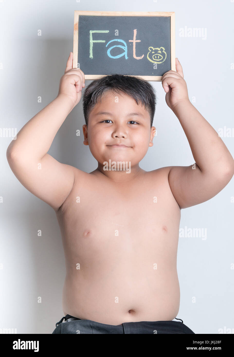 fat boy show blackboard on gray background Stock Photo - Alamy
