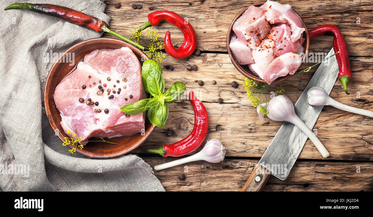 Raw rustic pork meat with chili, spices and herbs Stock Photo - Alamy