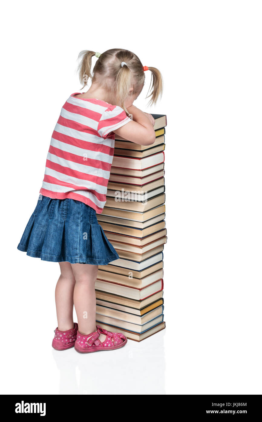 Little child is crying leaning on a pile of books, isolated on a white ...
