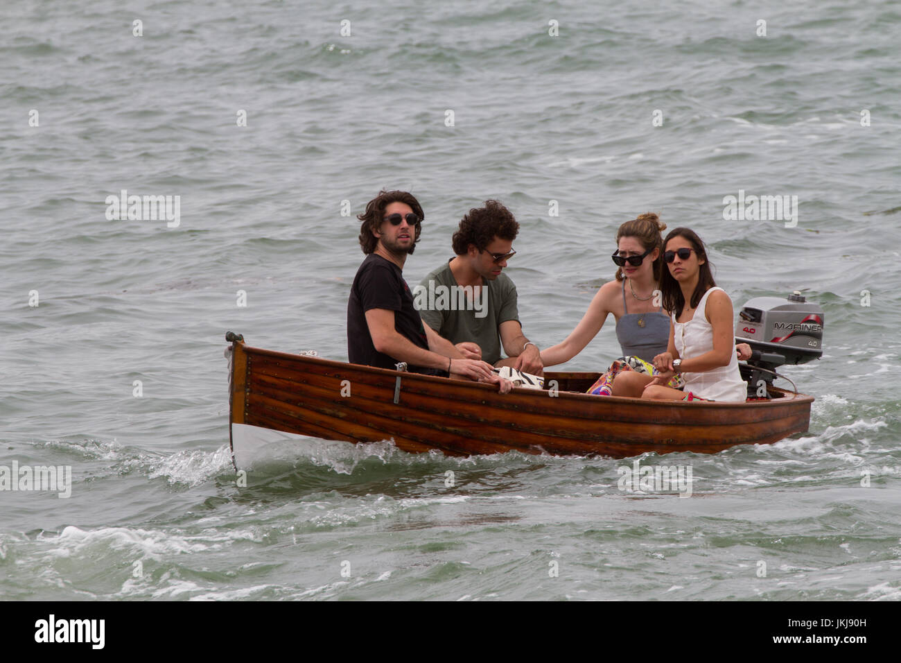 Group of four people in small boat. Venice. Italy Stock Photo - Alamy