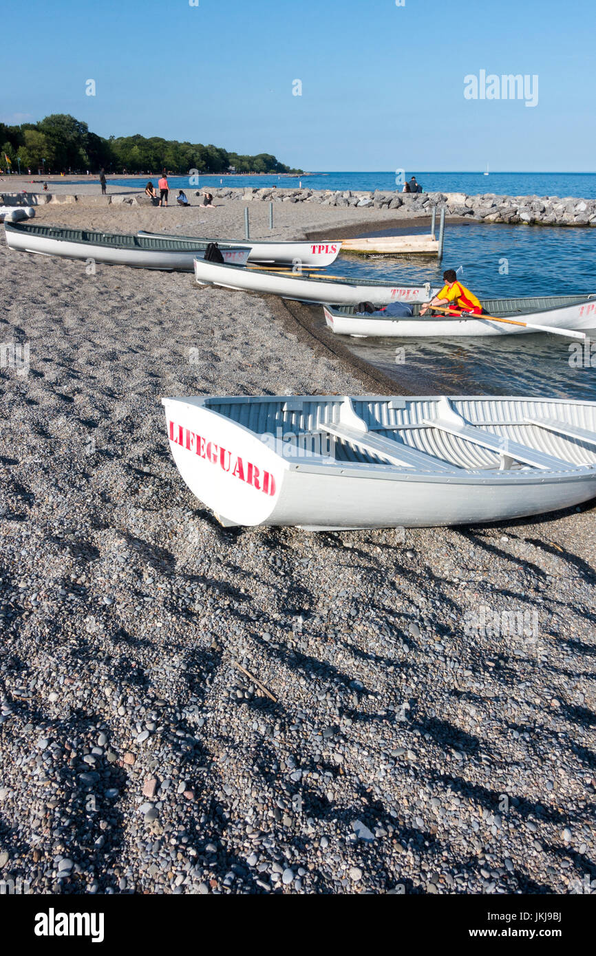 Wooden lifeboats used by local lifeguards at Kew beach on the shores of ...
