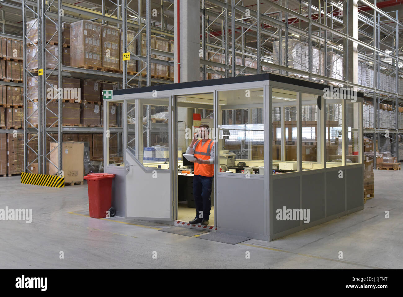 Man in control room of factory hall on the phone Stock Photo - Alamy