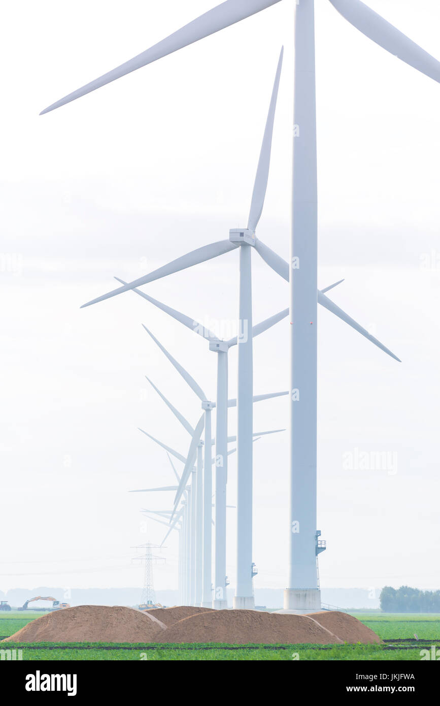 row of wind turbines in early morning in a flat dutch landscape Stock ...
