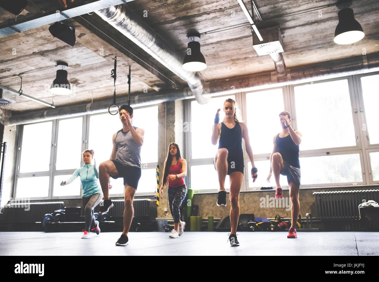 Group of young people exercising in gym Stock Photo - Alamy