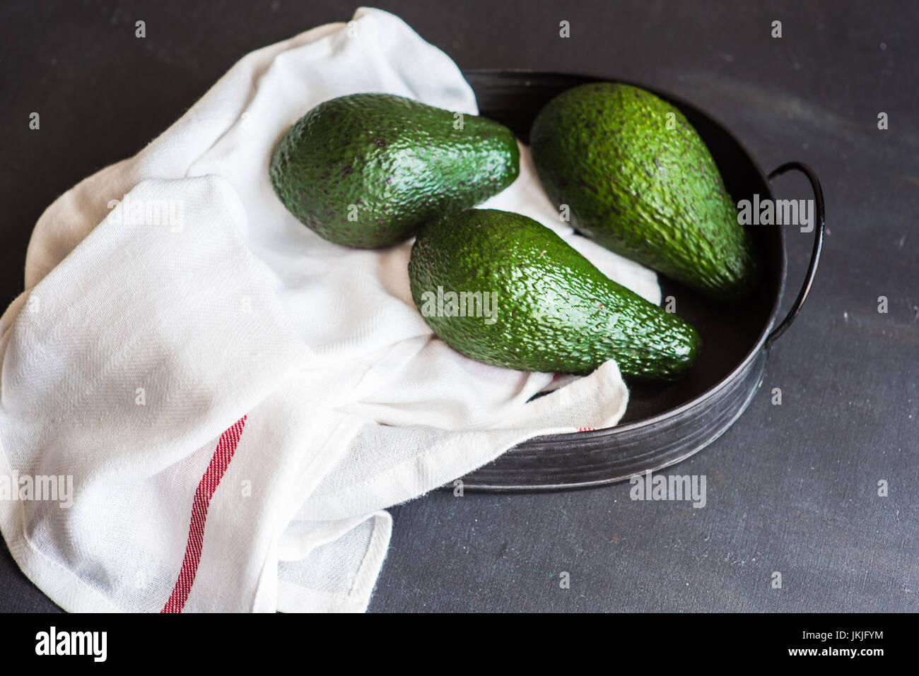 Three organic avocado on rustic wooden table Stock Photo - Alamy