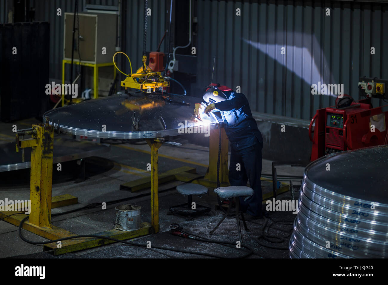 Worker welding in factory Stock Photo - Alamy