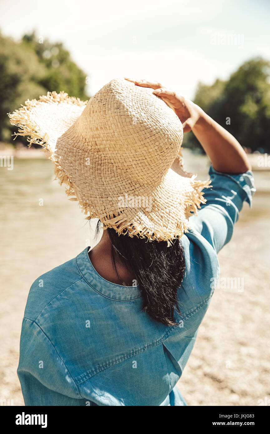 Back view of woman wearing straw hat Stock Photo - Alamy