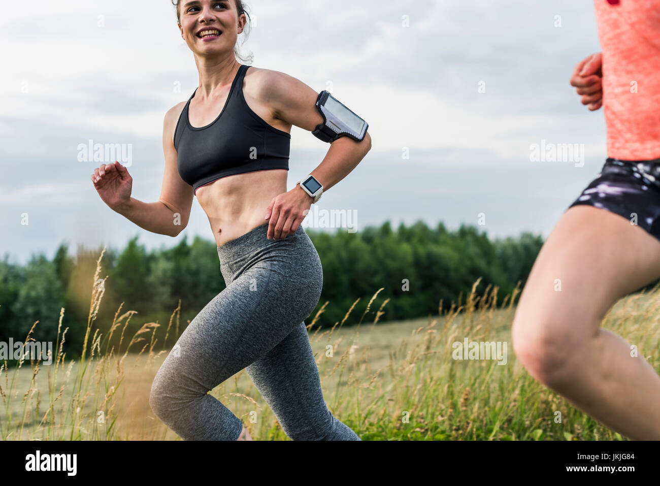 Two women running in the countryside Stock Photo - Alamy
