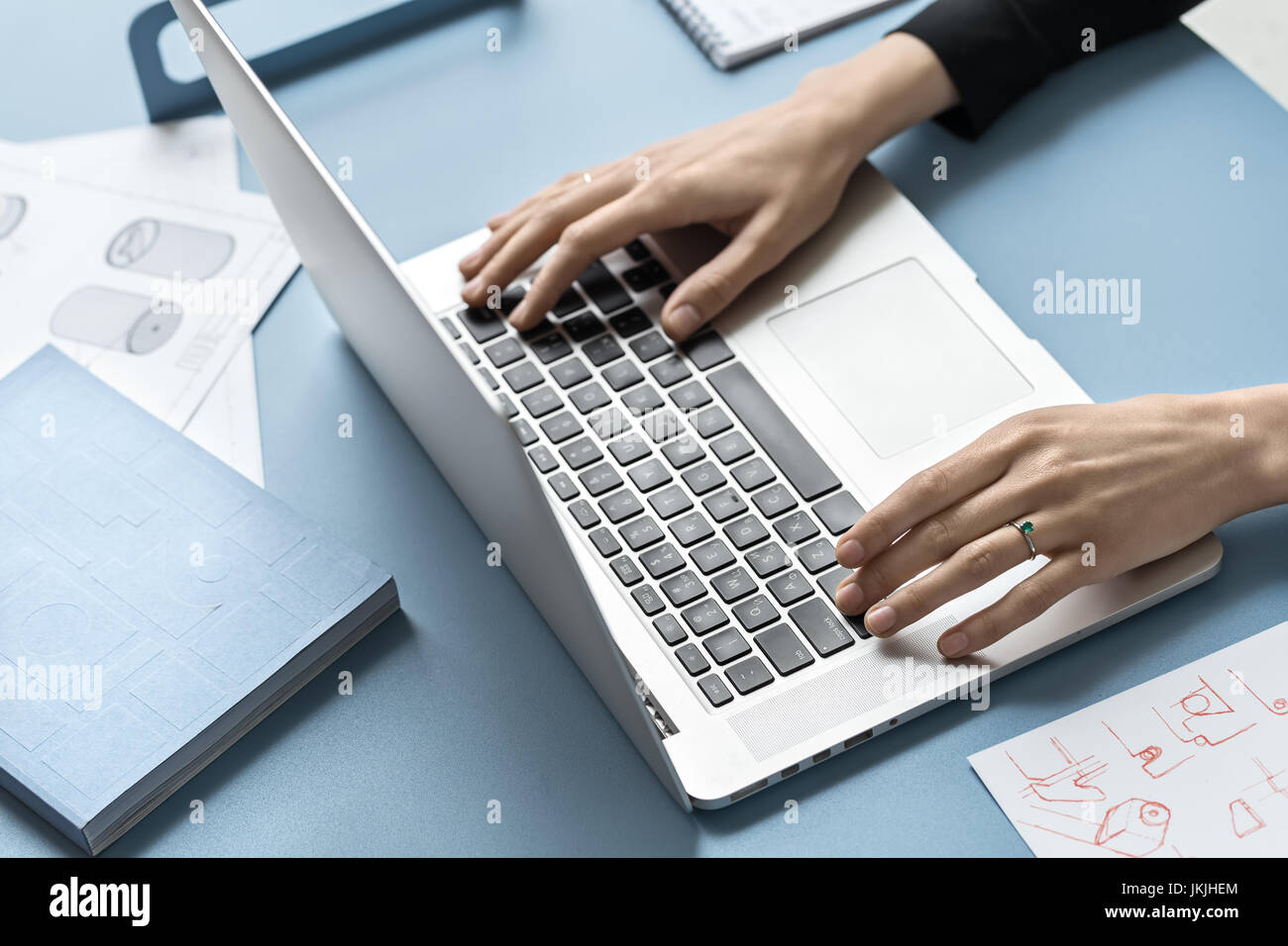 Girl using laptop in office Stock Photo - Alamy