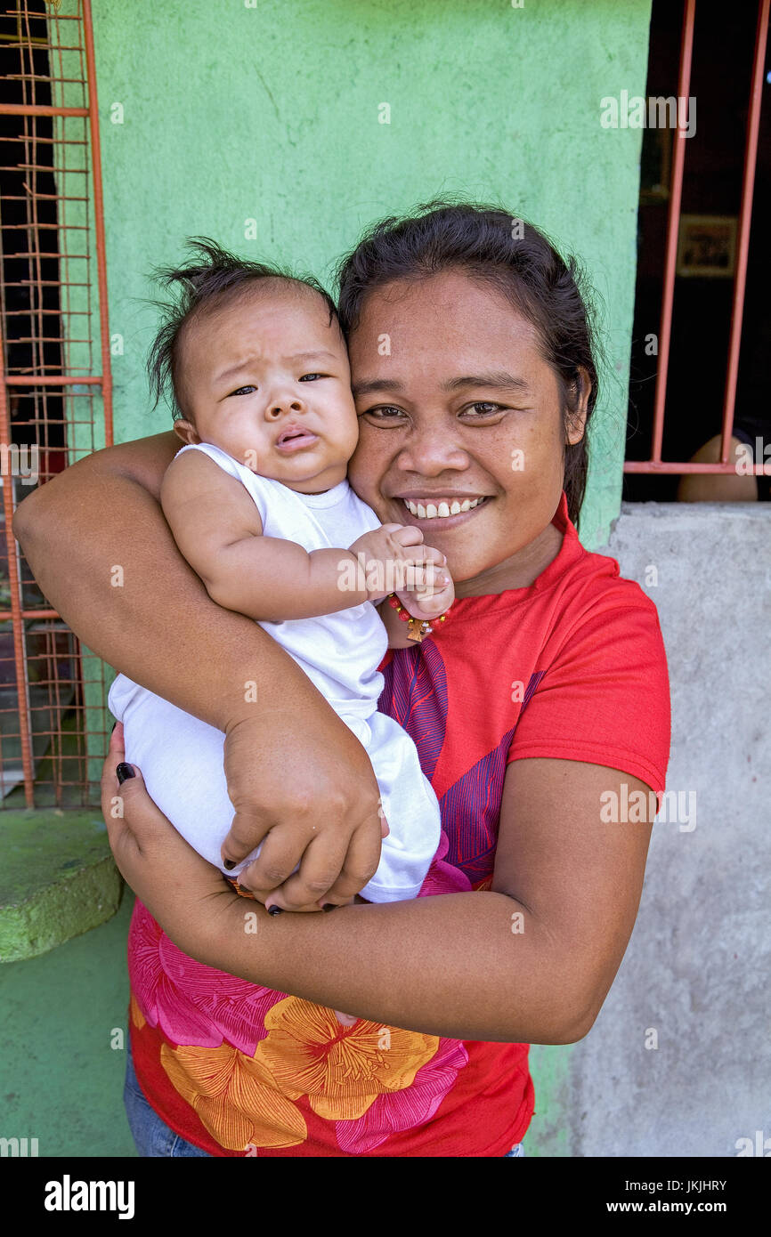 Portrait of a proud teenage Filipino woman with her infant child in ...