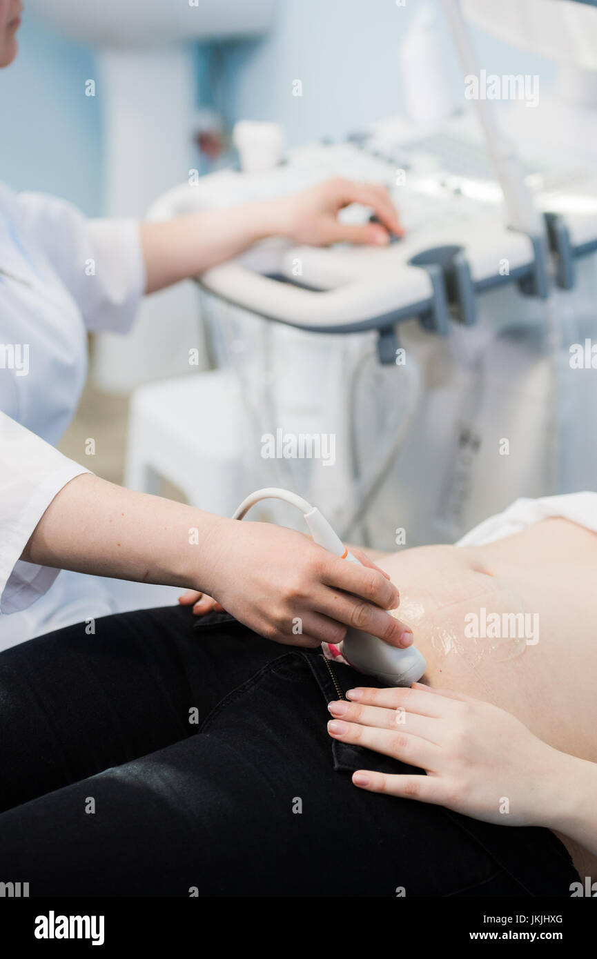 Close-up Of Doctor Moving Ultrasound Probe On Pregnant Woman's Stomach ...