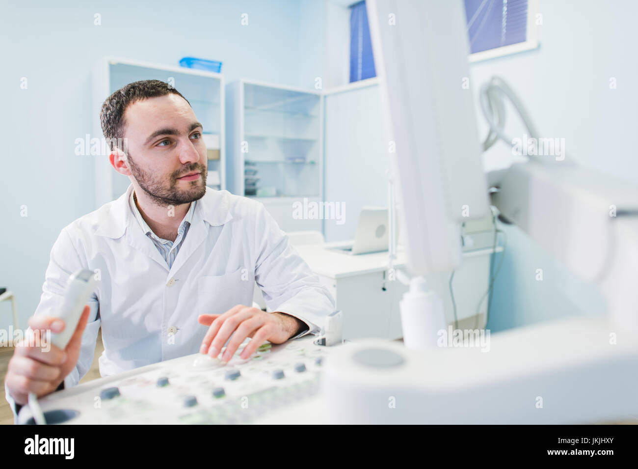 Portrait of a thinking doctor near sceen of medical equipment Stock ...