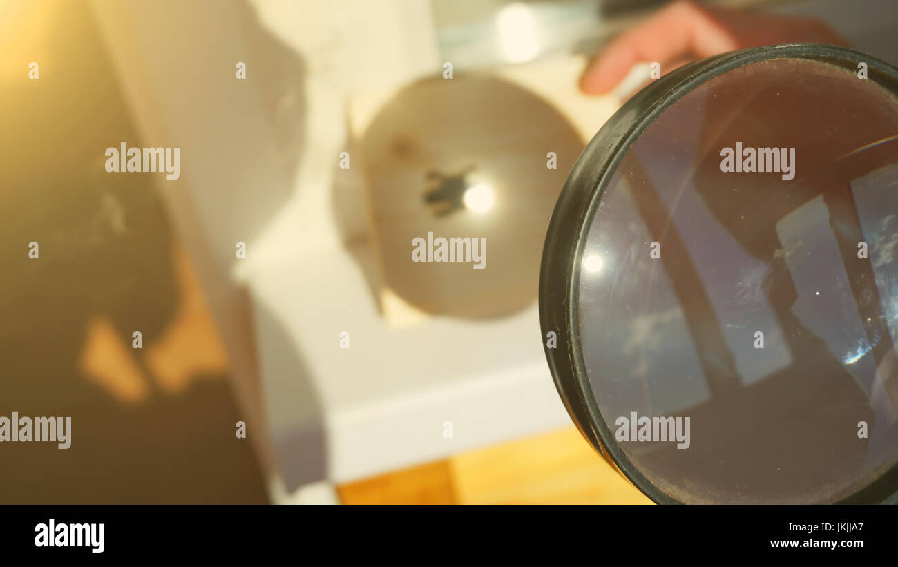Sunlight focused by a converging magnifying glass can burn wooden bar ...