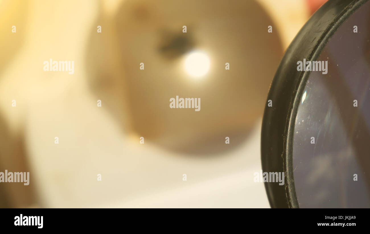 Sunlight focused by a converging magnifying glass can burn wooden bar ...