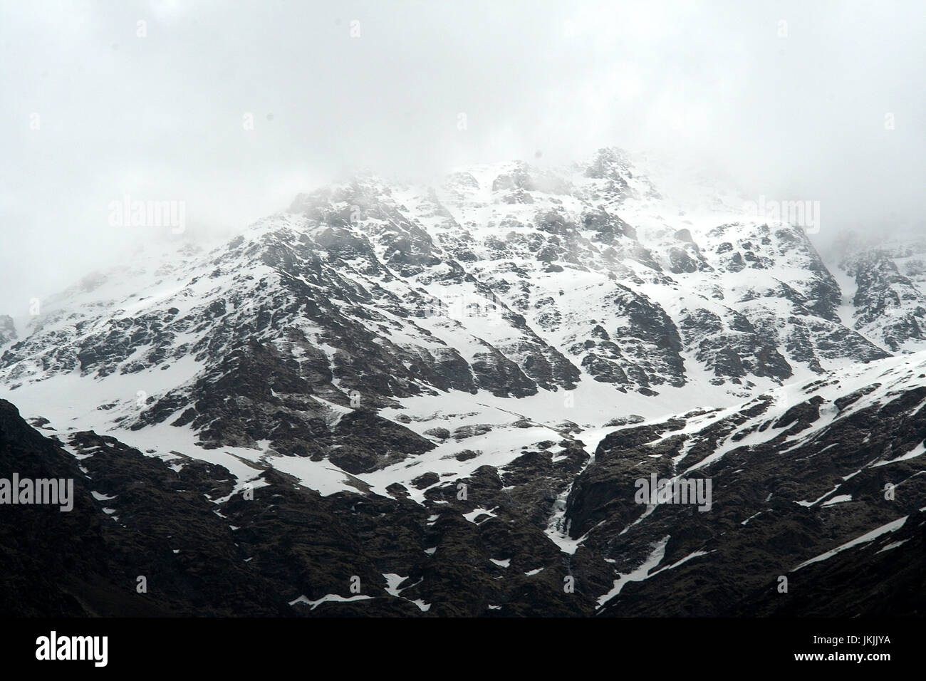 Snow covered Himalayan Mountain viewed from trekking path to Yamunothri ...
