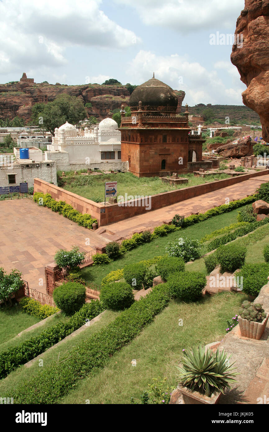 Masjid with garden in foreground and temple on distant hill at Badami ...