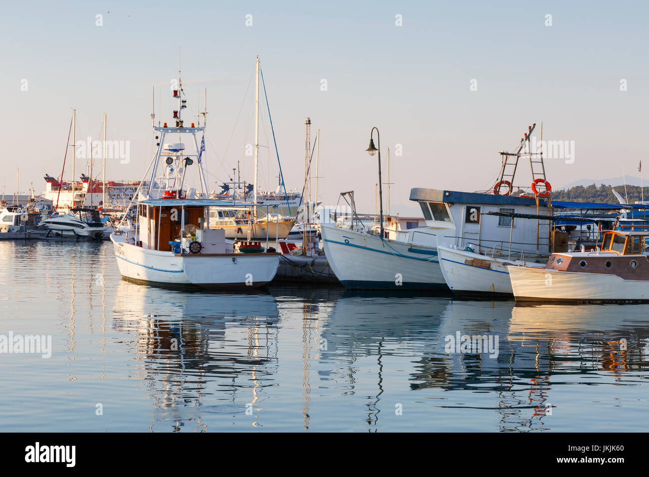 Fishing boats in the port of Volos city as seen early in the morning ...