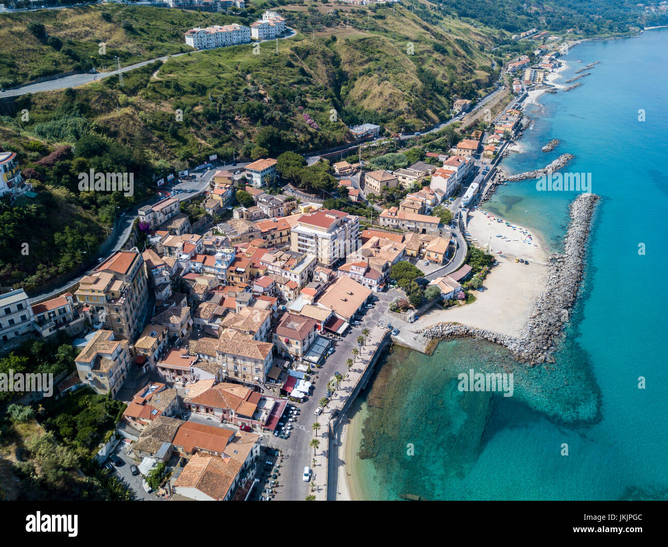 Aerial view of a beach and a pier with canoes, boats and umbrellas ...