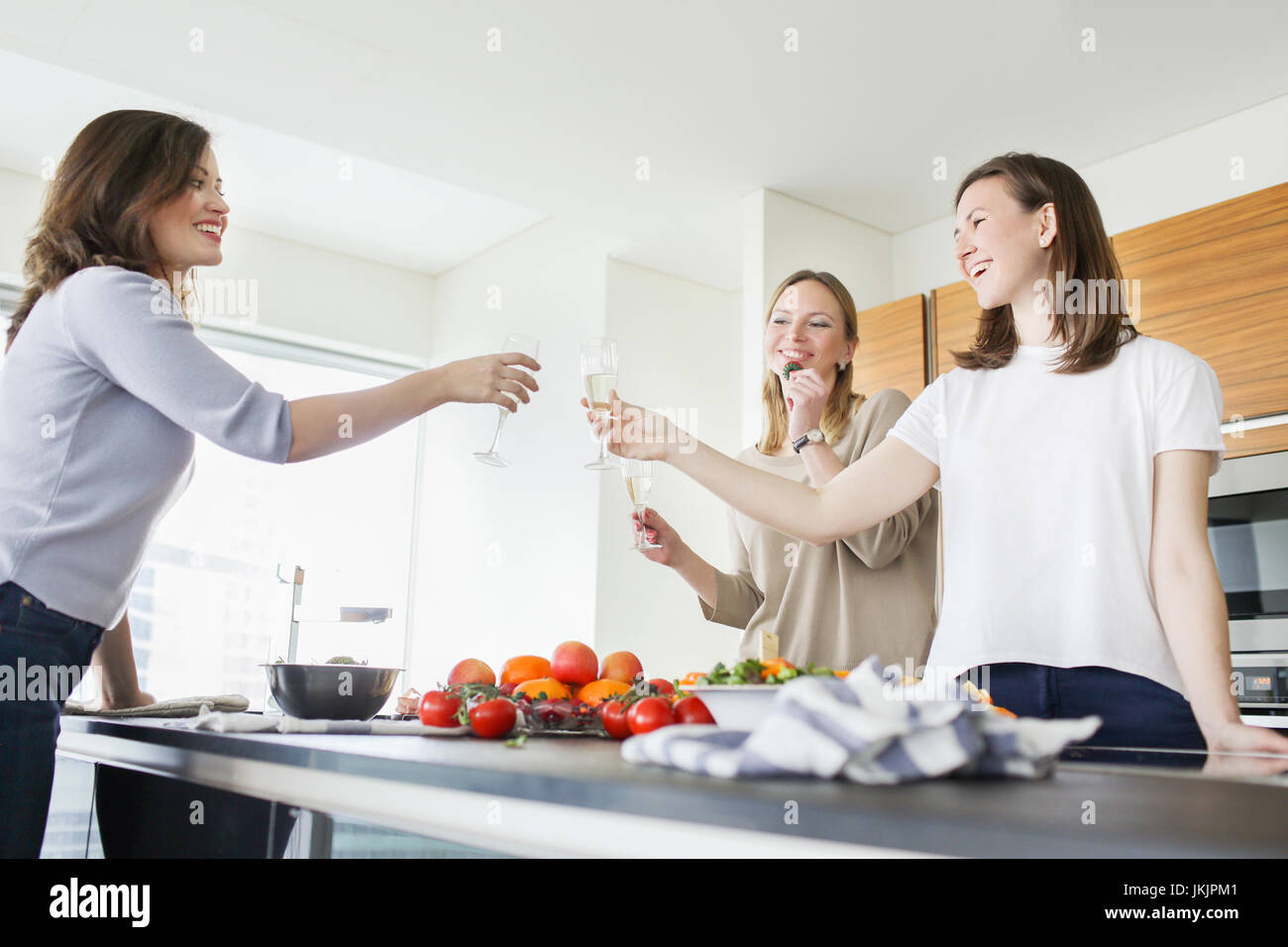 Group of happy women toasting at party in the kitchen Stock Photo - Alamy