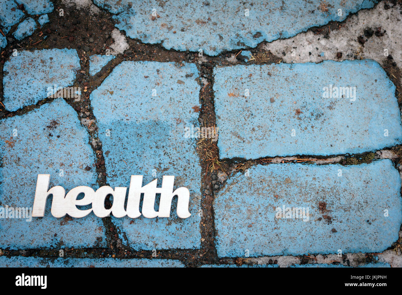 Health sign on stone pavement background Stock Photo - Alamy