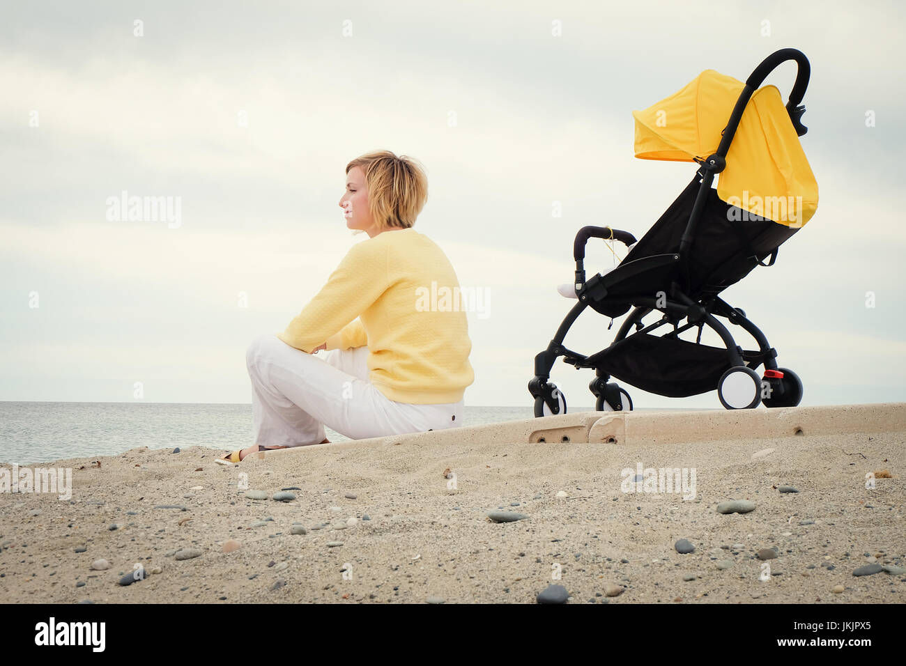 Young mother gets some rest outdoors Stock Photo - Alamy