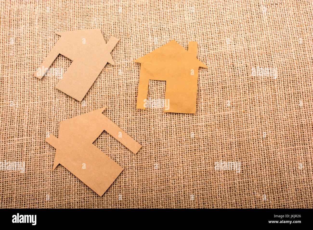Little house shape cut out of paper on a canvas background Stock Photo ...